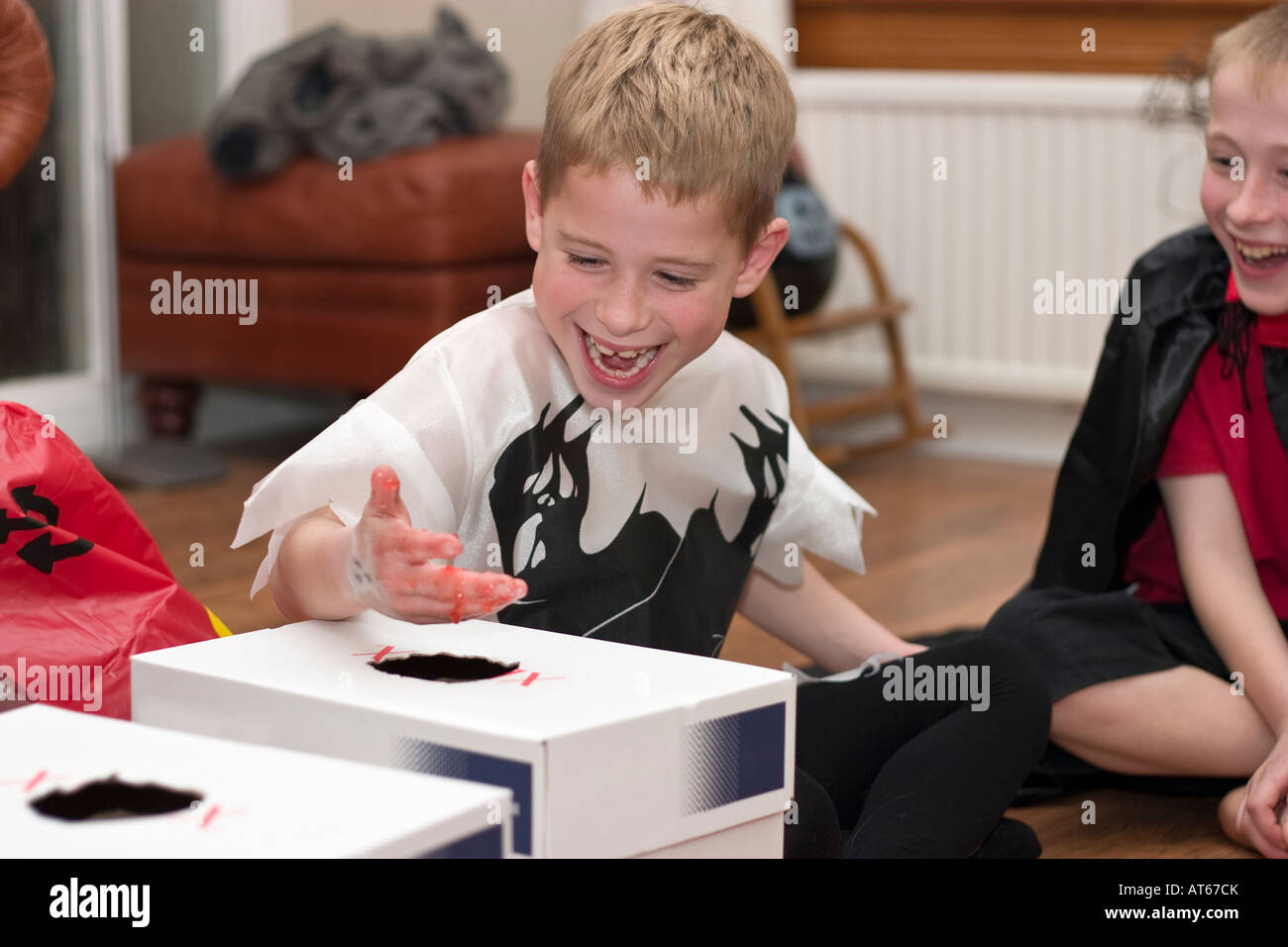 Kids playing Halloween mystery box game Stock Photo - Alamy