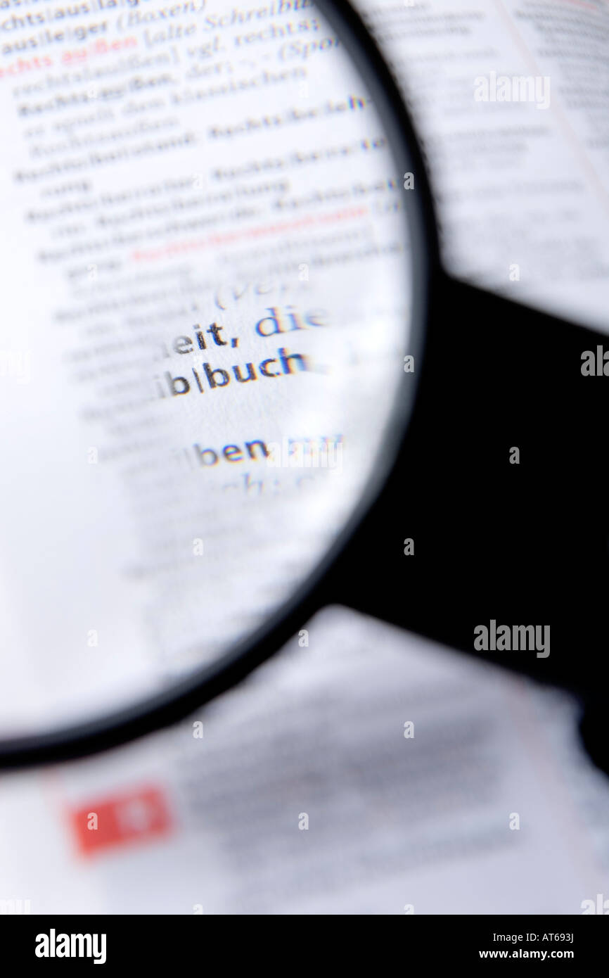 Magnifying glass on encyclopedia, close-up Stock Photo - Alamy