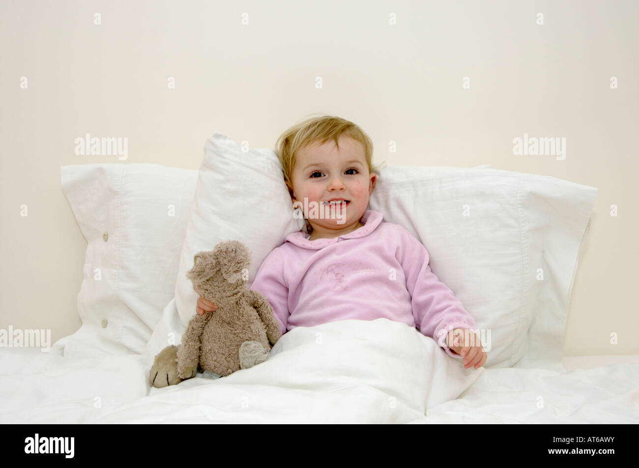 child in bed with soft toy Stock Photo - Alamy