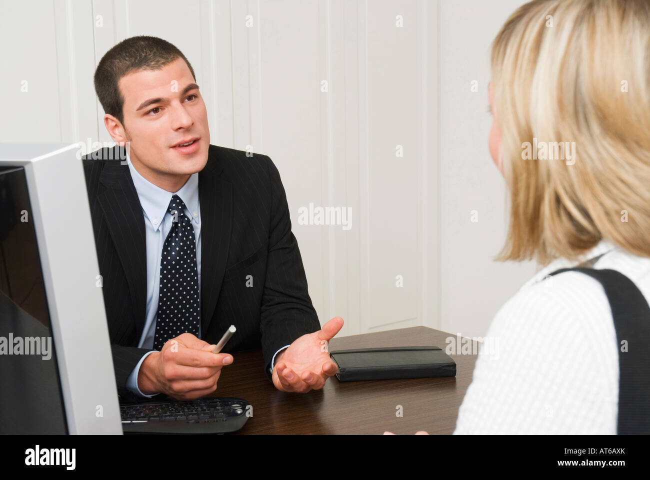 Bank representative talking with client Stock Photo - Alamy