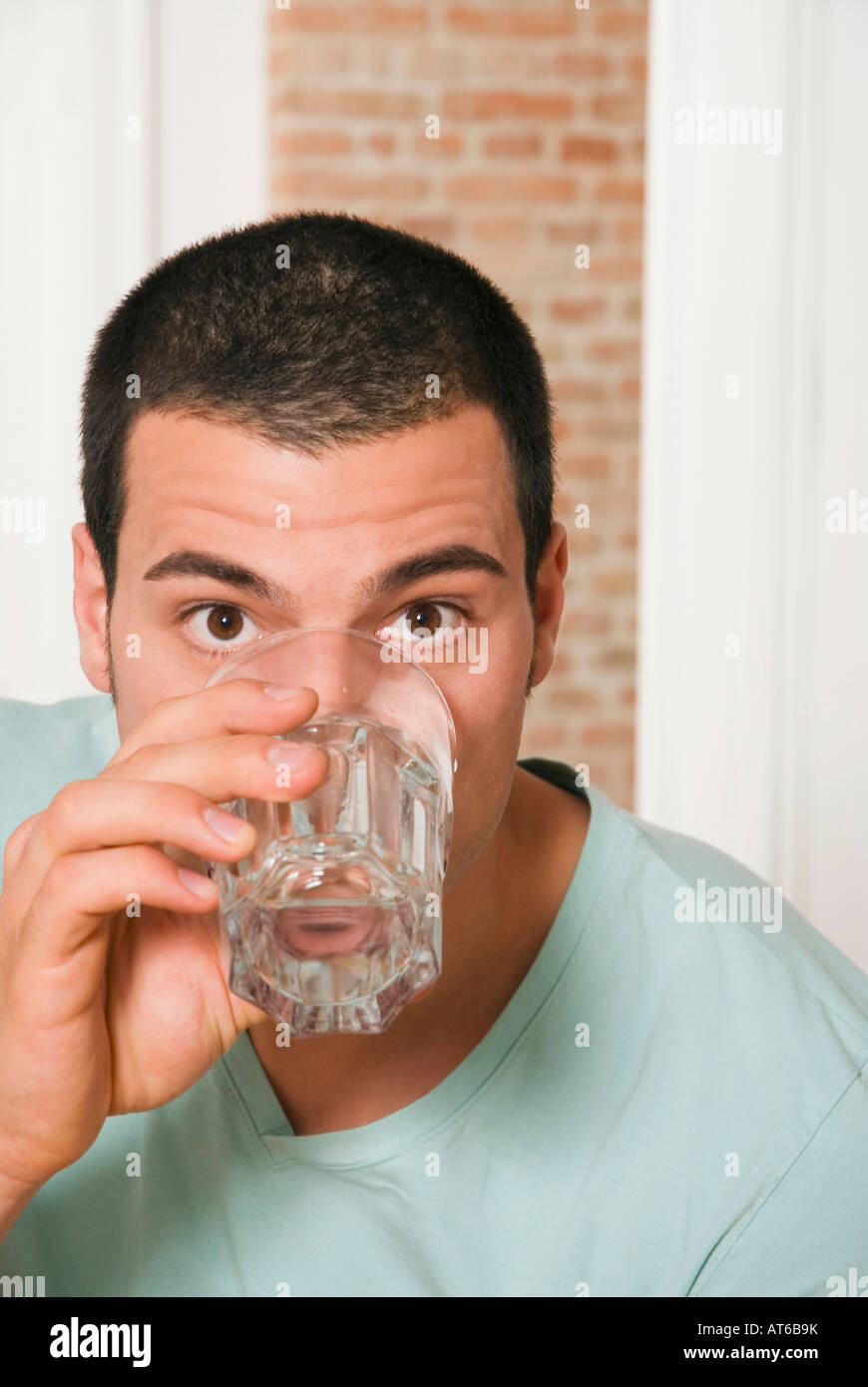 Man drinking a glass of water, portrait Stock Photo - Alamy