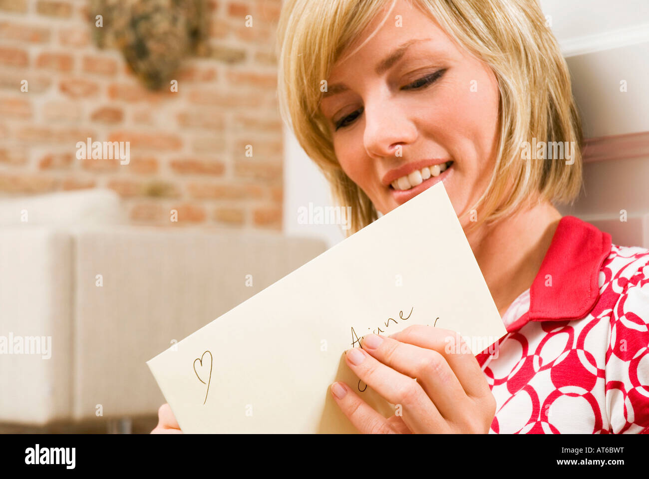 Young woman holding mail, portrait, close-up Stock Photo - Alamy