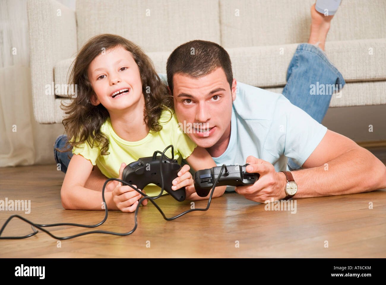 Father and daughter (8-9) playing computer game Stock Photo - Alamy