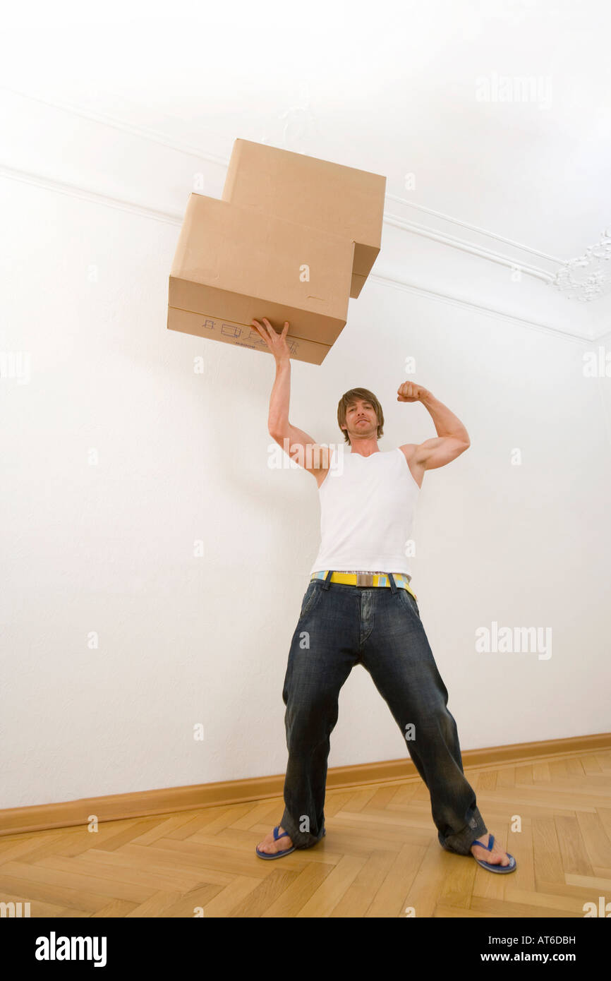 Man balancing cardboard box on hand Stock Photo - Alamy
