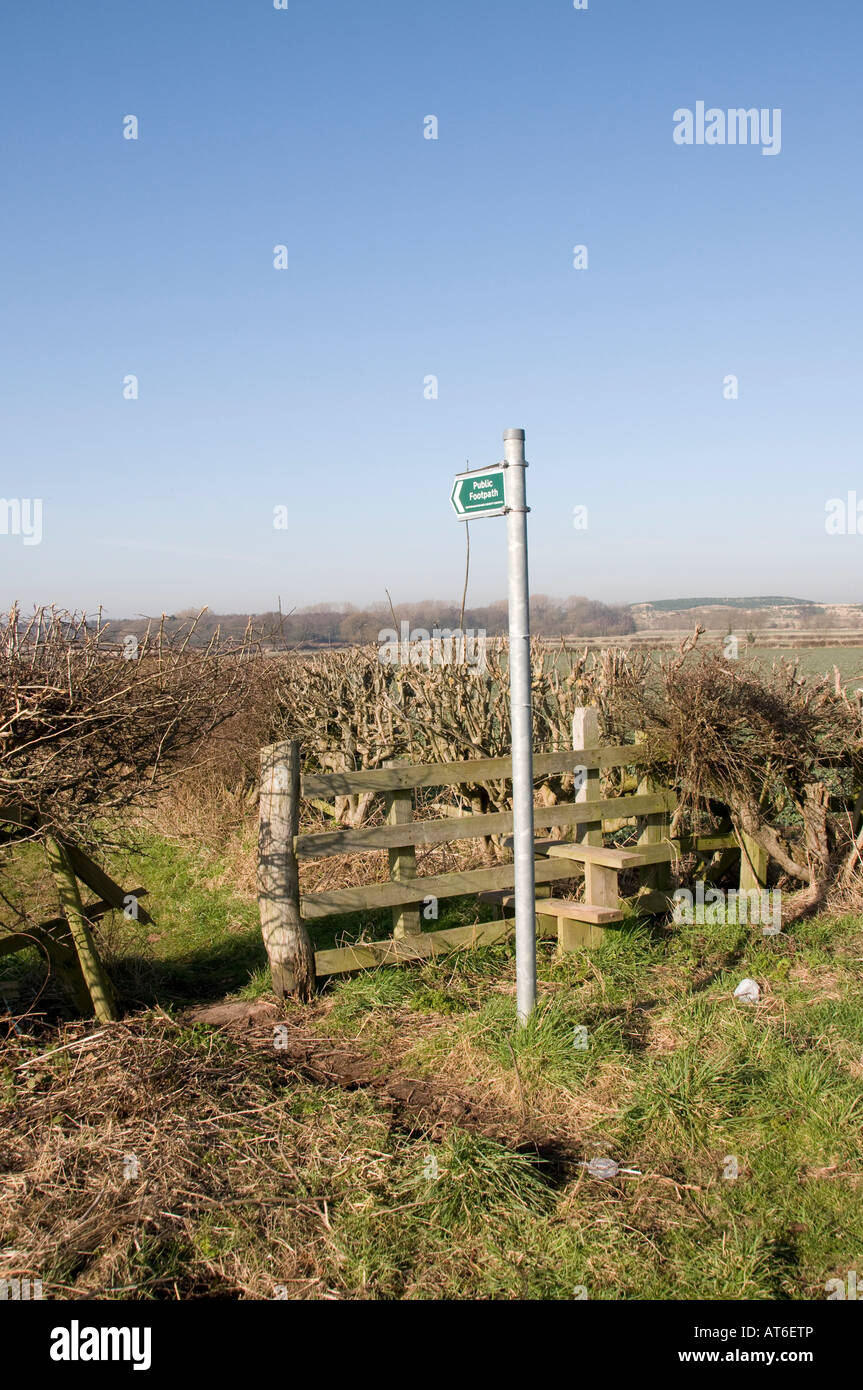 public footpath sign, directing over stile into field Stock Photo - Alamy