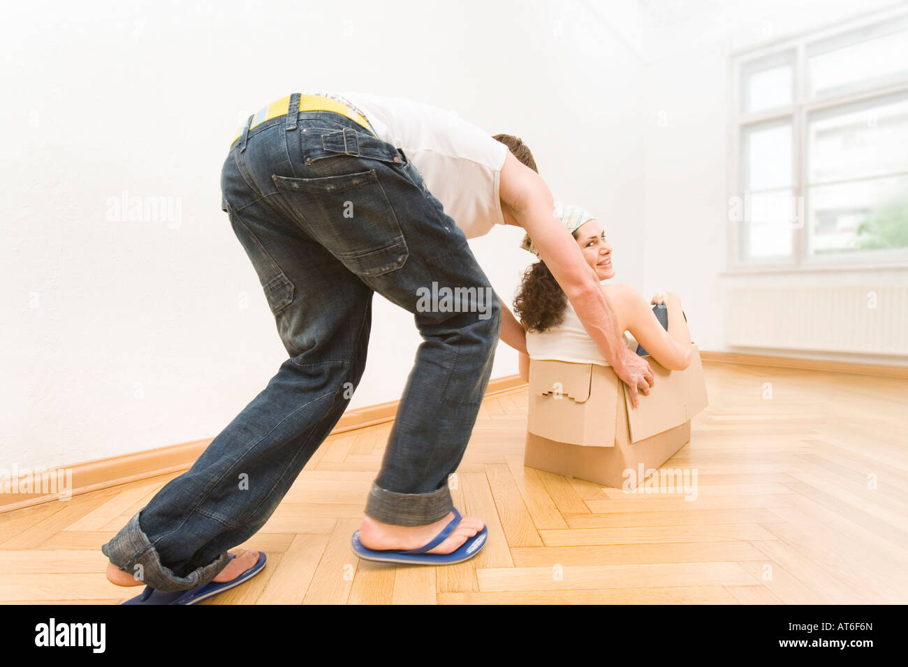 Woman in cardboard box being pushed Stock Photo - Alamy