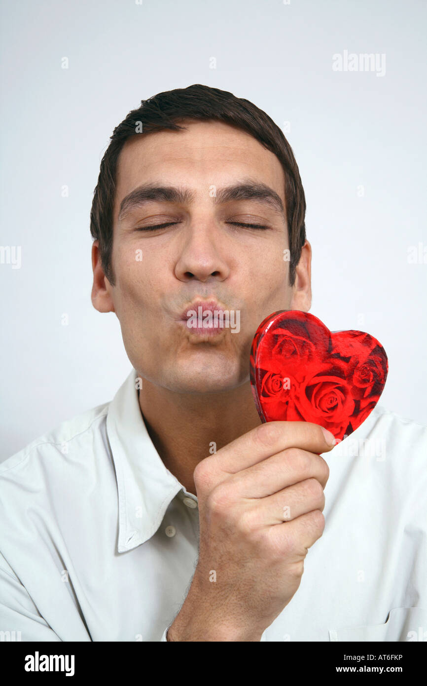 Man holding red heart, close-up Stock Photo - Alamy