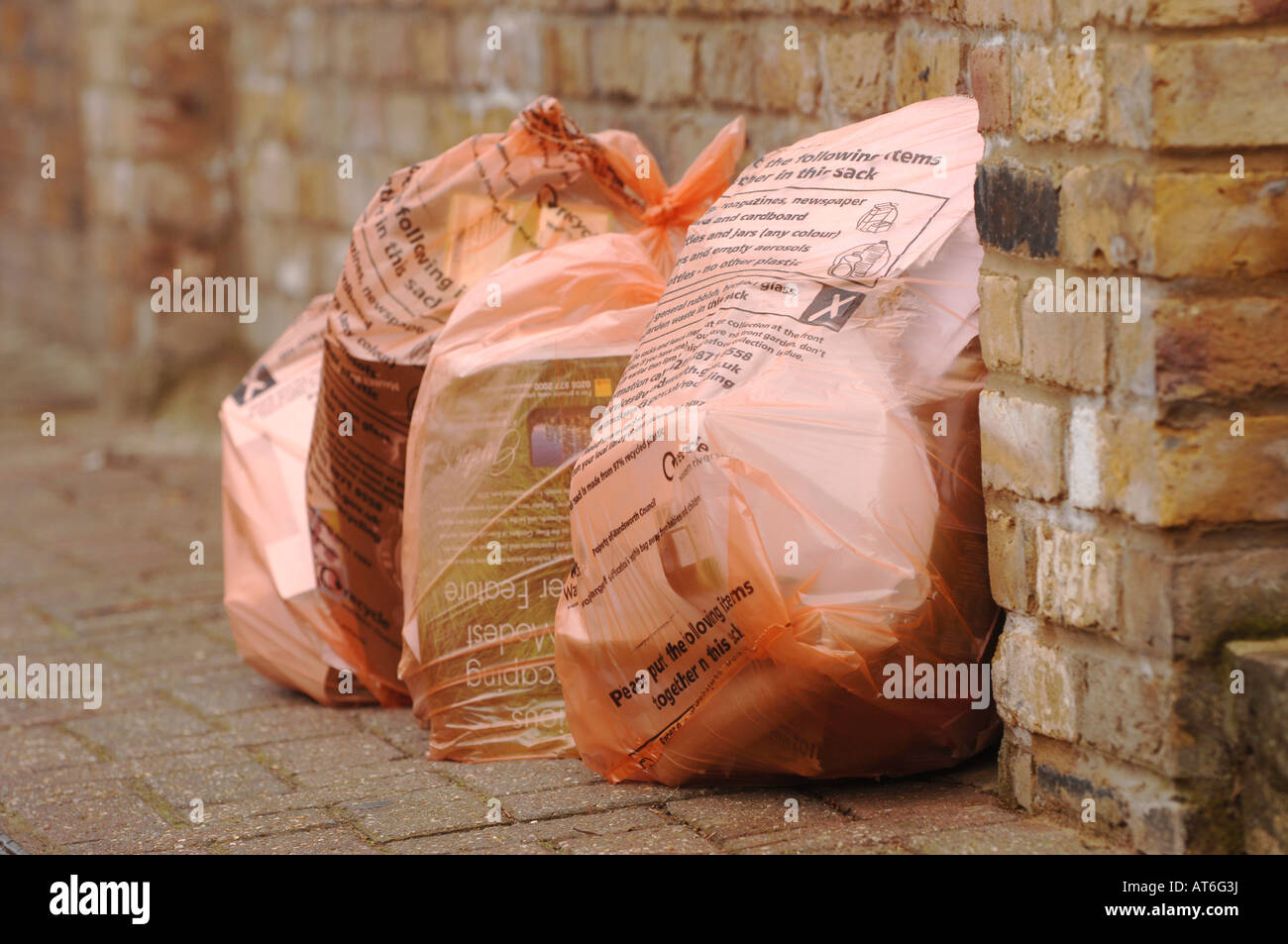 Orange recycling bags awaiting collection Stock Photo - Alamy
