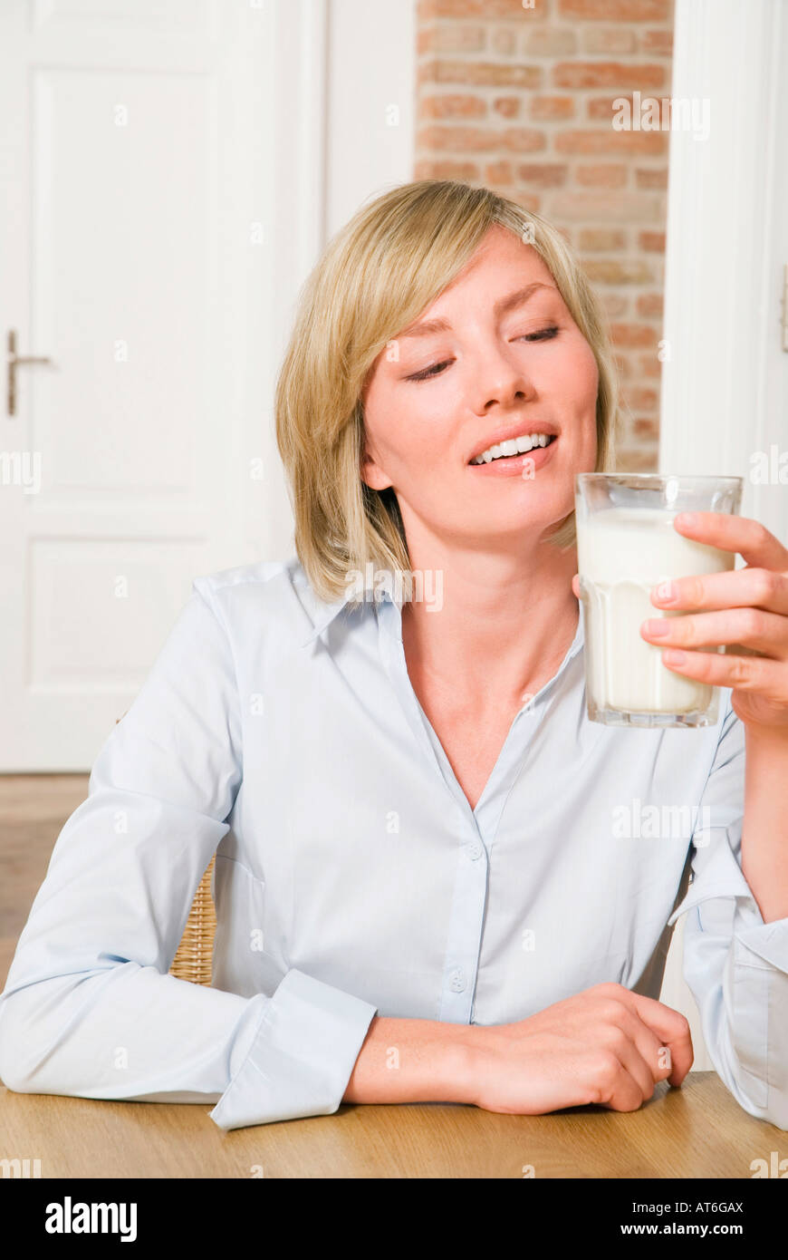 Young woman holding glass of milk, portrait, close-up Stock Photo - Alamy