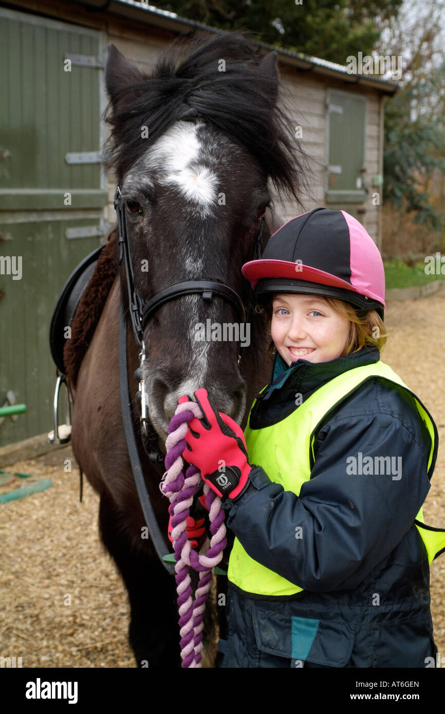 Pony Rider Little Girl holding her pet Cob Pony Stock Photo - Alamy