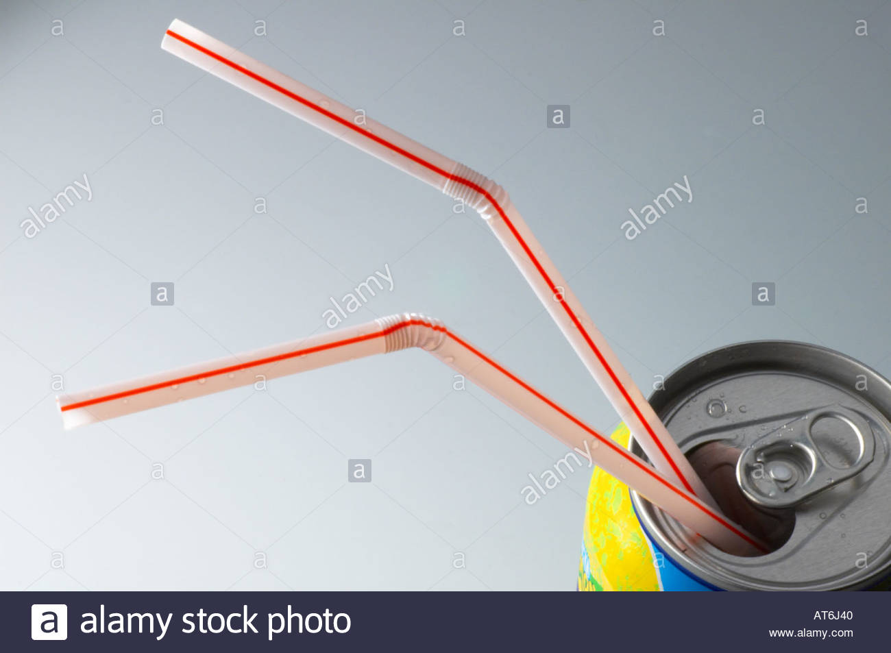 Closeup of a drinks can and striped drinking straw Stock Photo - Alamy