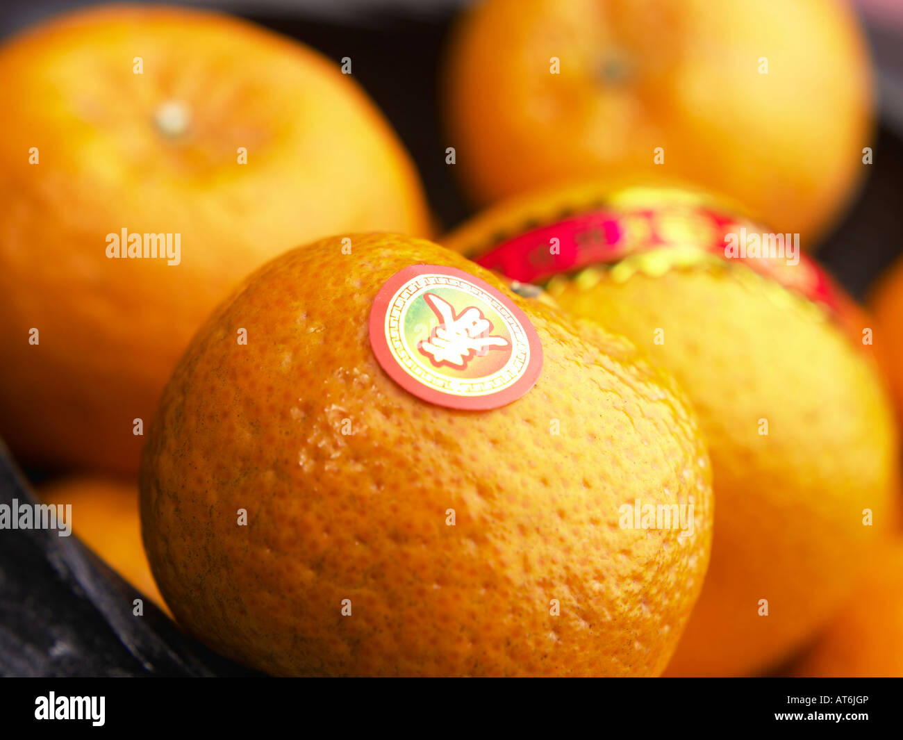 close up of mandarin oranges with red sticker Stock Photo - Alamy