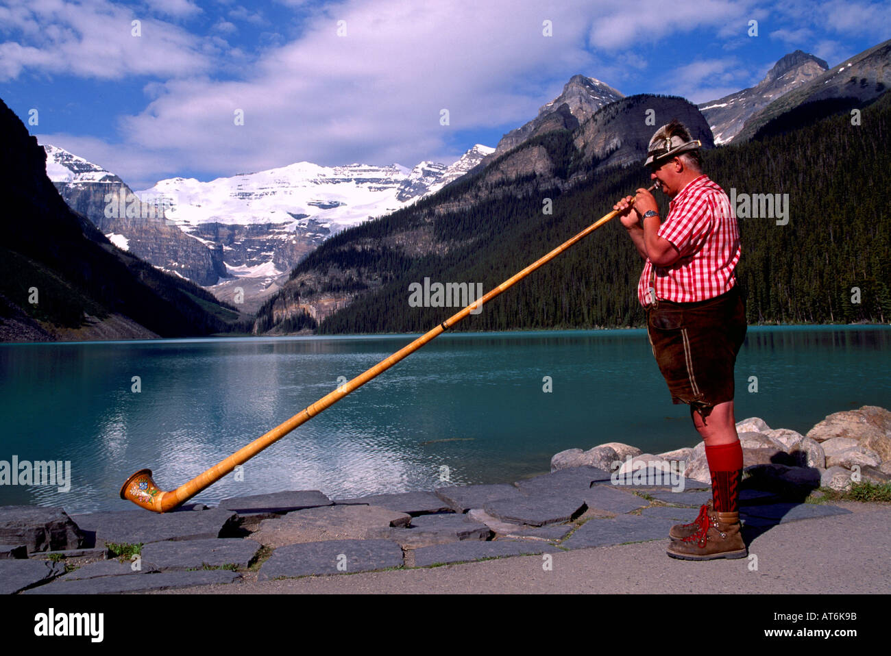 An Alpenhorn Player blowing an Alphorn at Lake Louise in Banff National ...