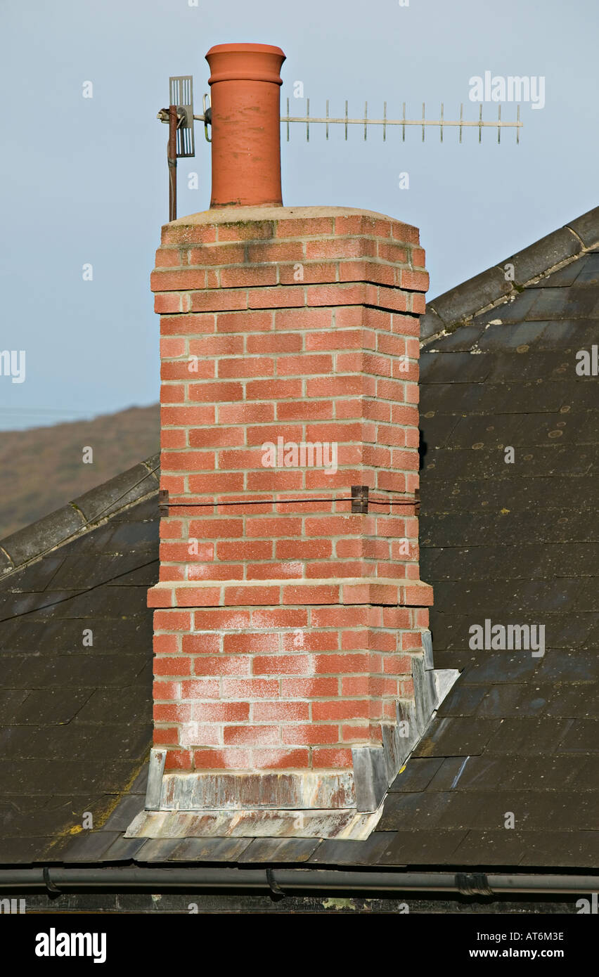 Chimney pot on brick stack with television aerial on domestic house ...
