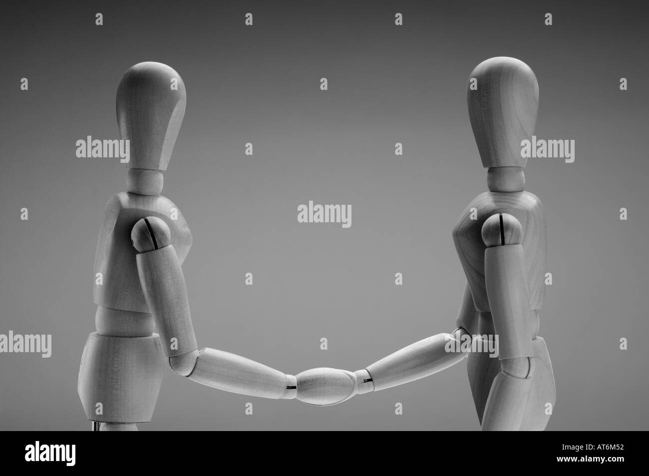 Carved wooden figures with hand shake Stock Photo - Alamy