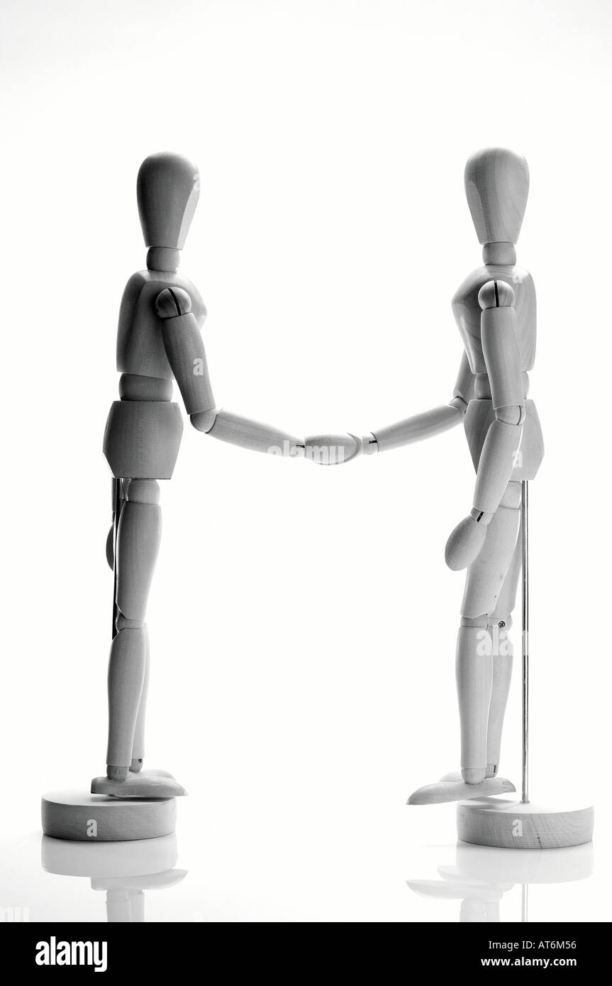 Carved wooden figures with hand shake Stock Photo - Alamy
