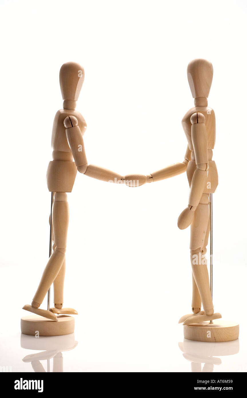 Carved wooden figures with hand shake Stock Photo - Alamy