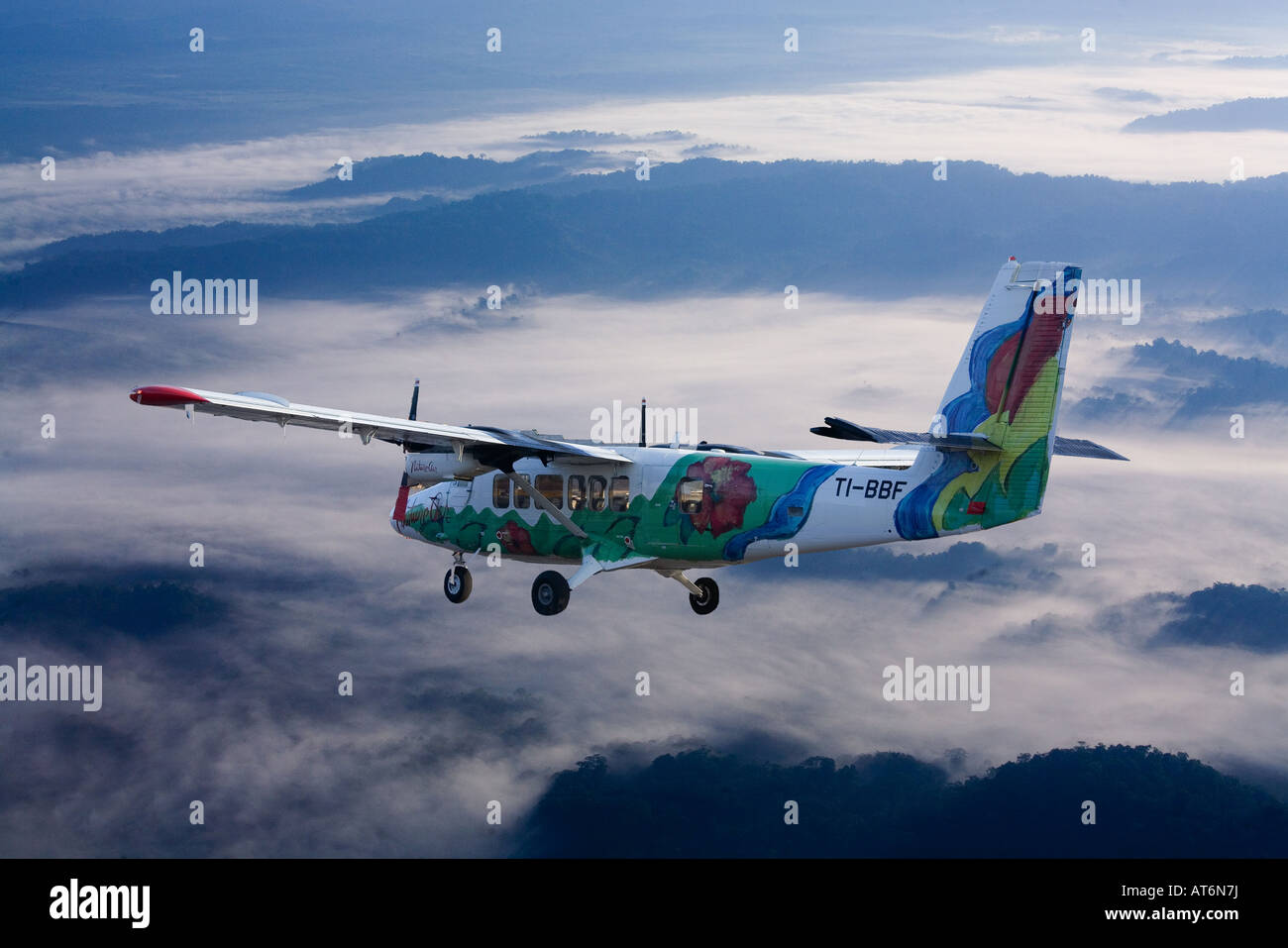 Twin engine plane flying over the jungle in Costa Rica Stock Photo - Alamy