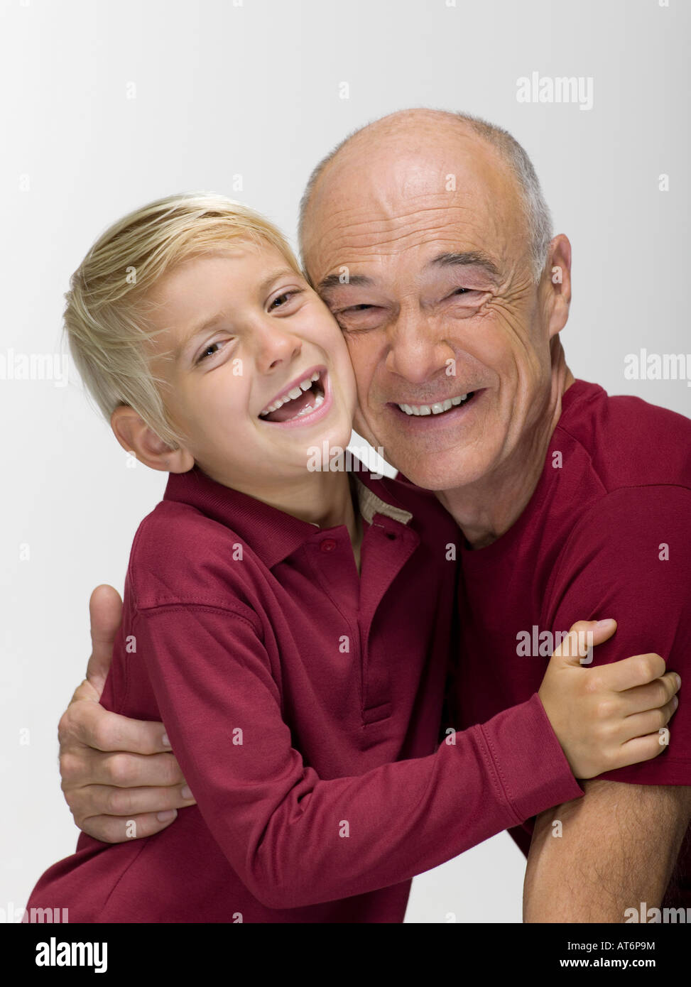 Grandson (8-9) embracing grandfather, smiling, portrait Stock Photo - Alamy