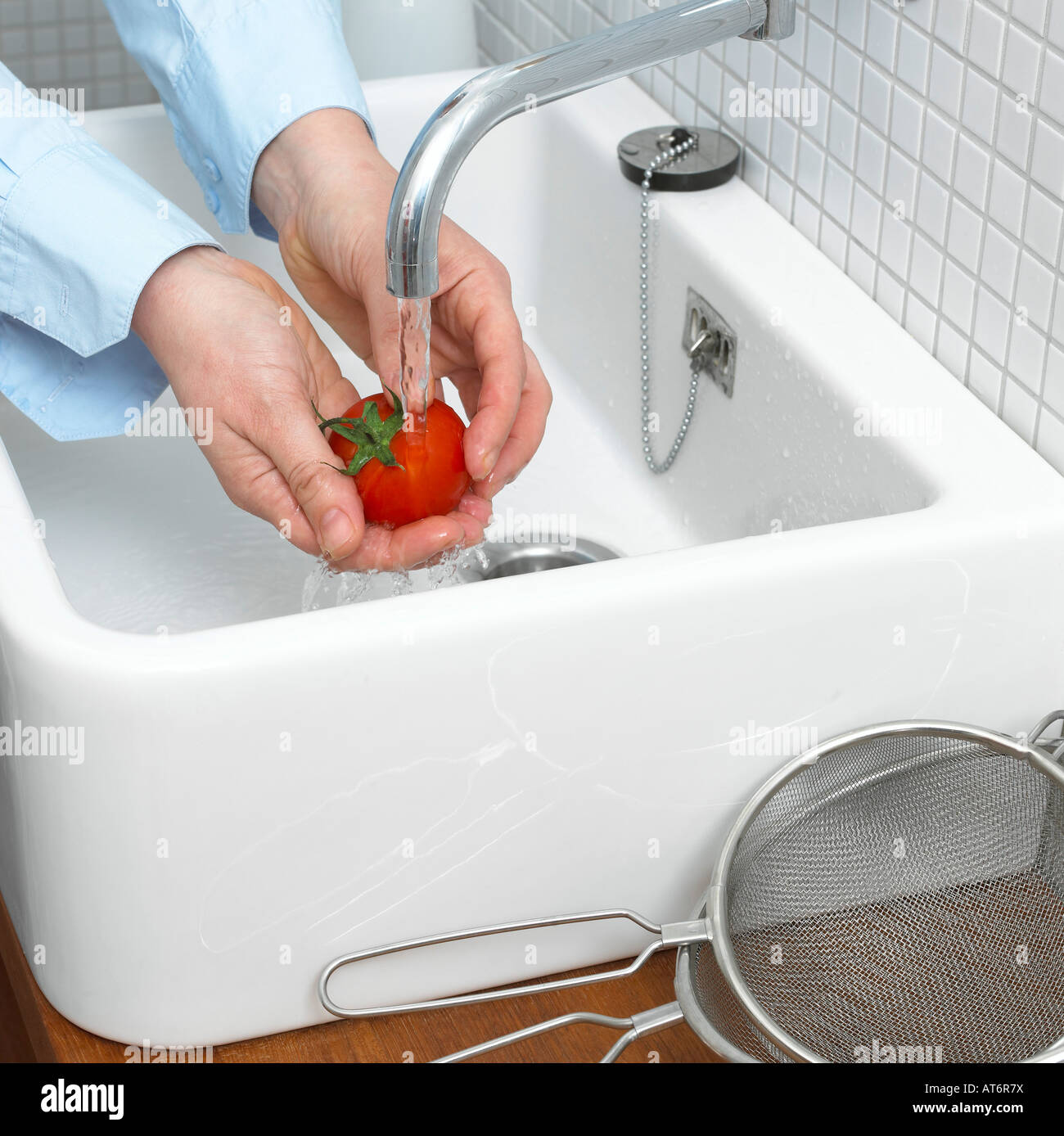 Hand's cleaning tomatoes, close-up Stock Photo - Alamy