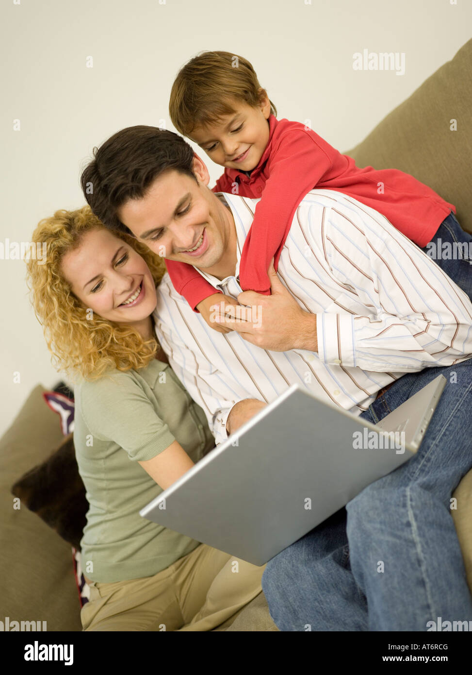 Young family in living room, father using laptop Stock Photo - Alamy