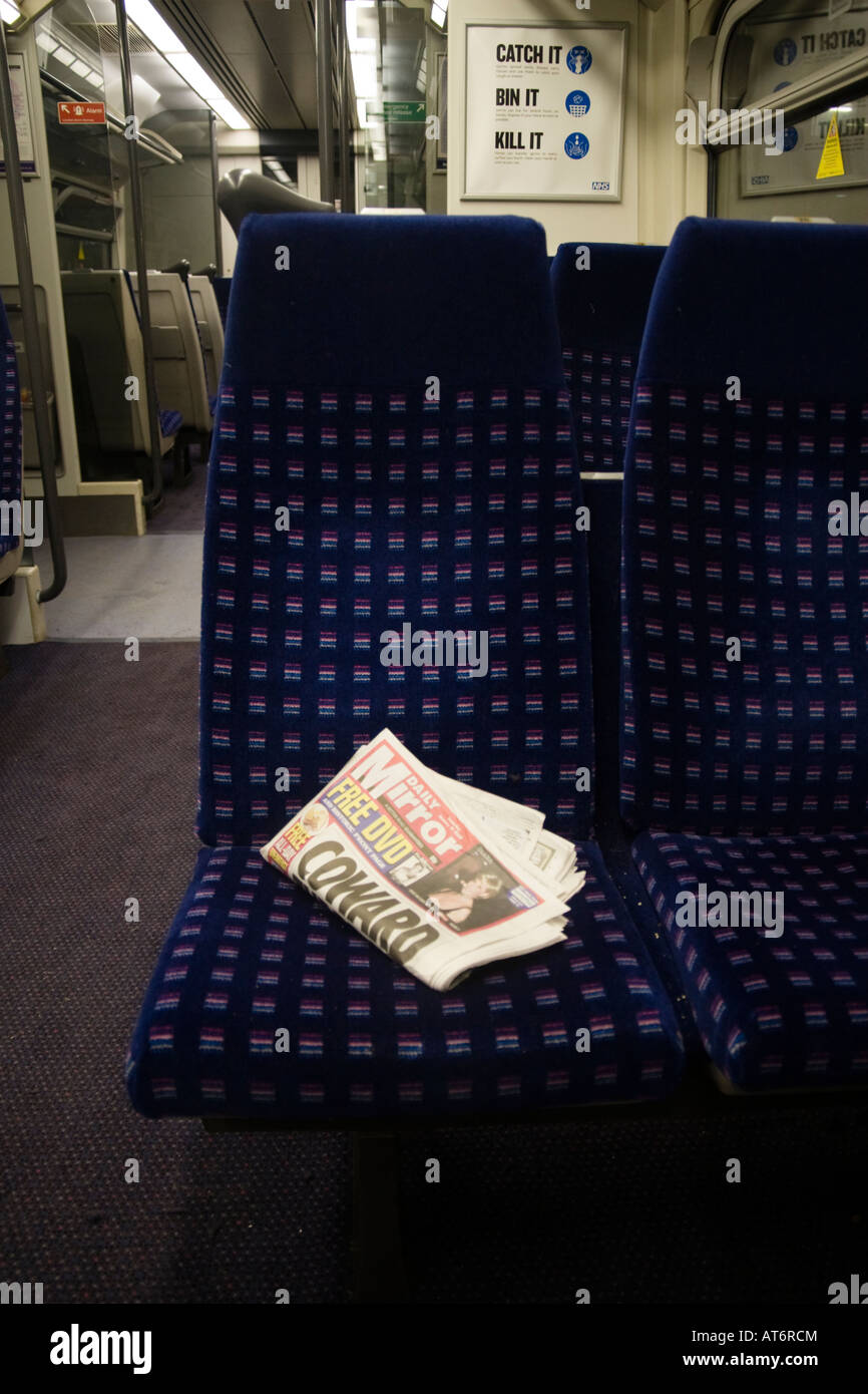 Newspaper on seat in empty train carriage Stock Photo - Alamy