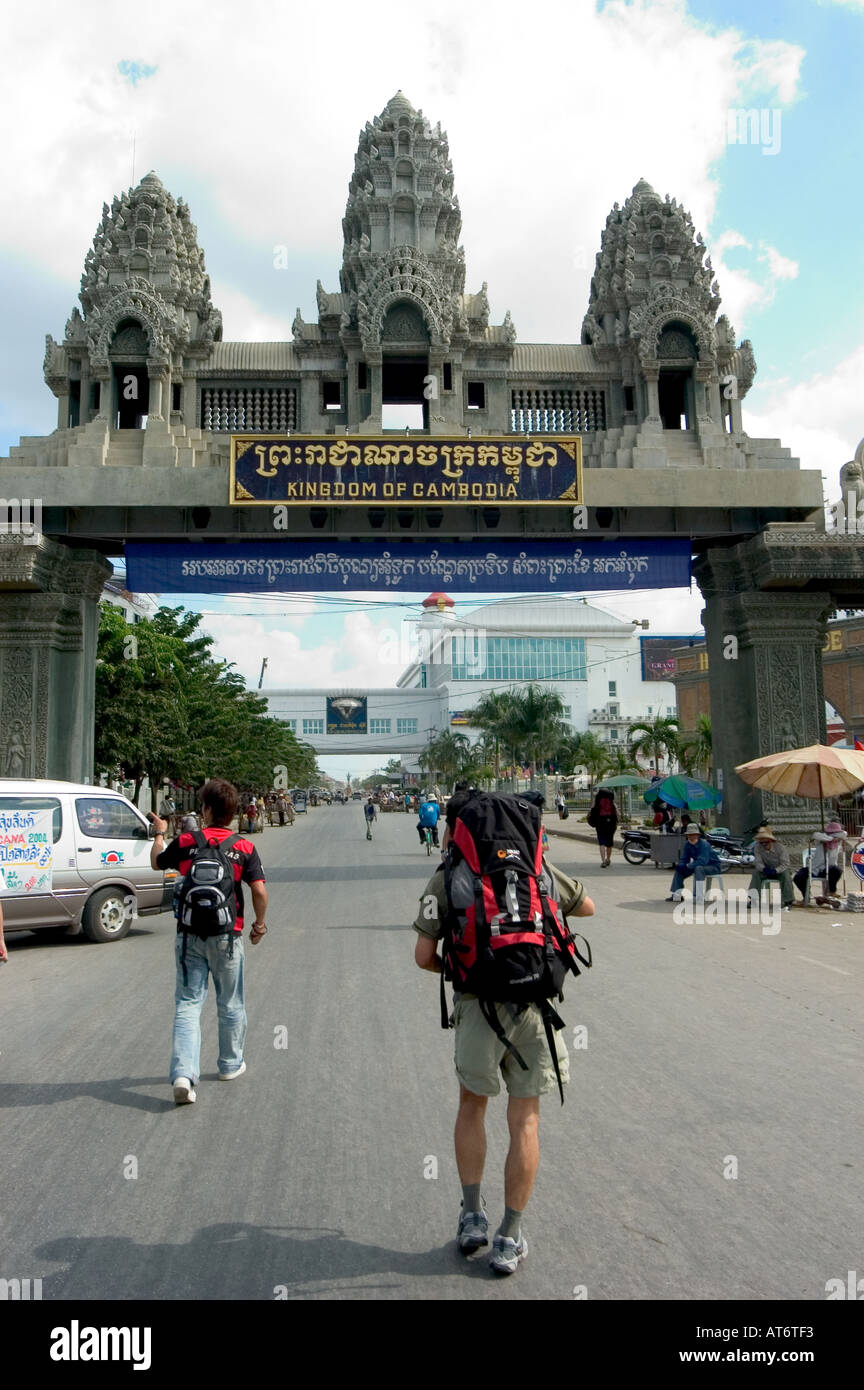 Border crossing backpackers crossing through Angkor style border gate ...