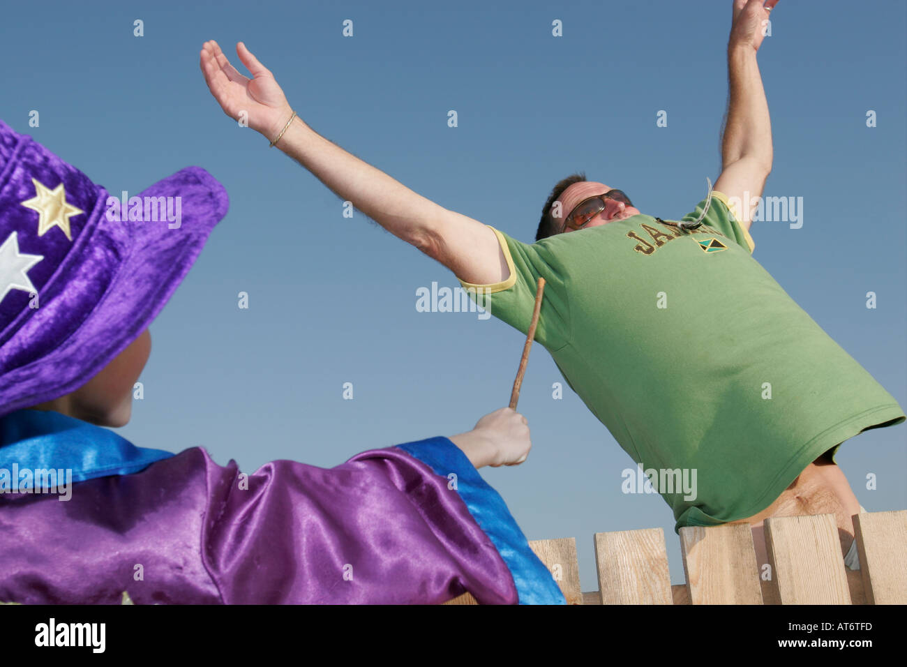 Child with magic wand playing with father Stock Photo - Alamy