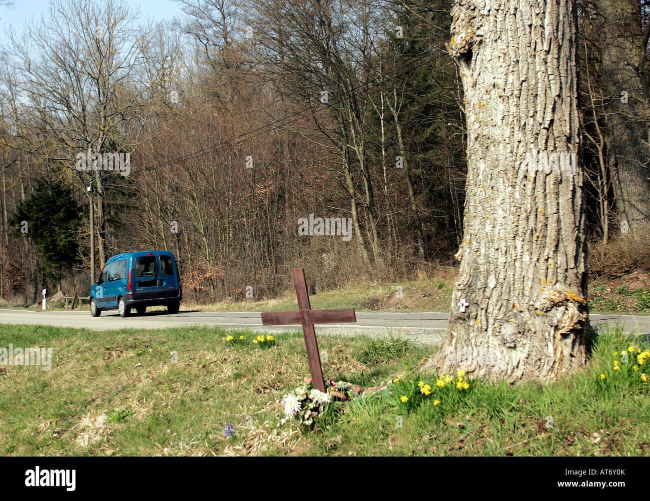 a wooden cross besides a street reminds of a victim who died in a road ...