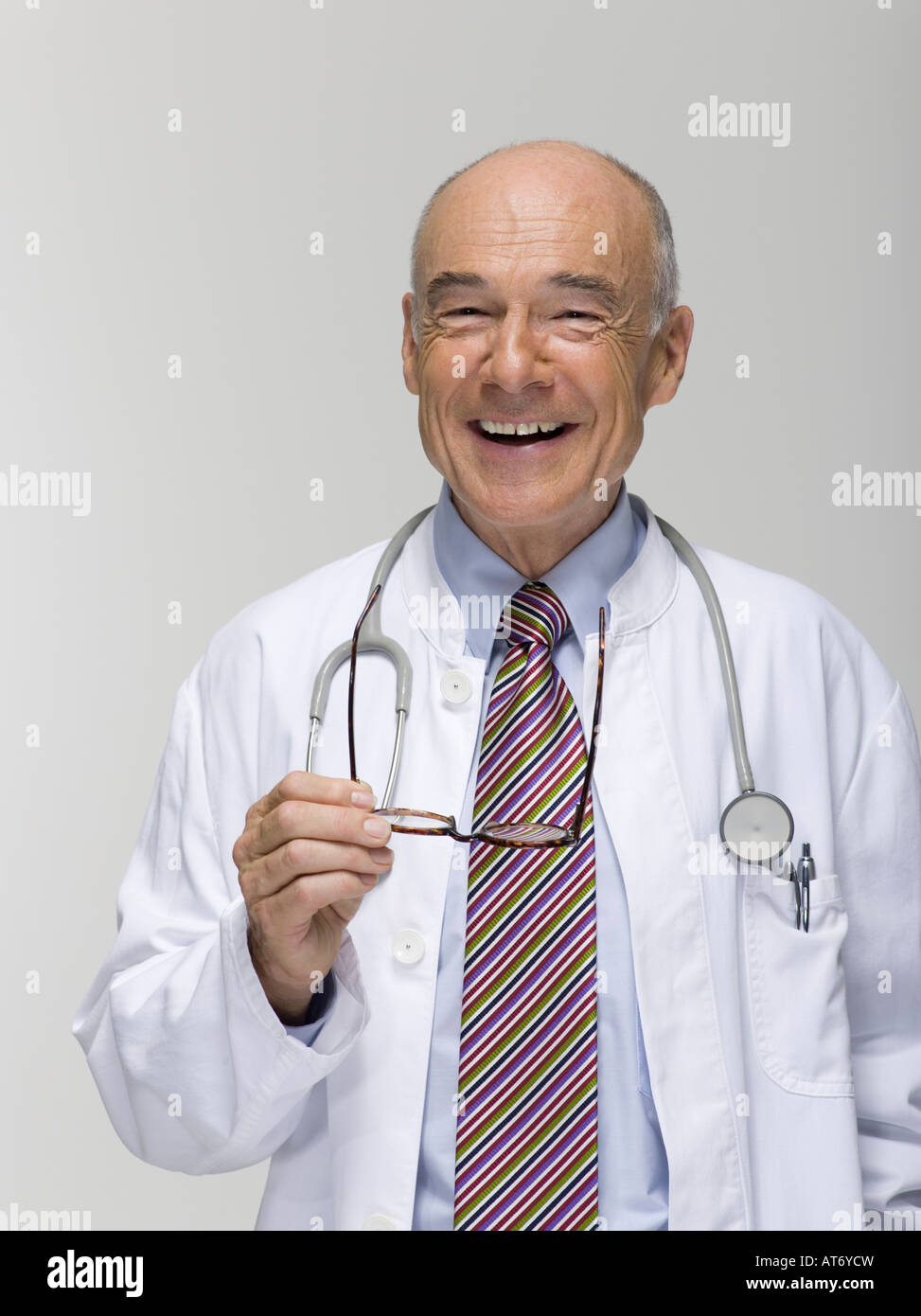 Senior male doctor laughing, portrait Stock Photo - Alamy
