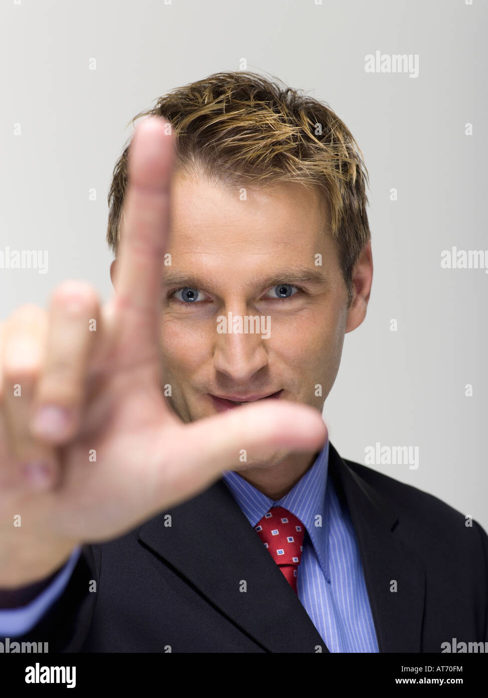Man showing two fingers suit hi-res stock photography and images - Alamy