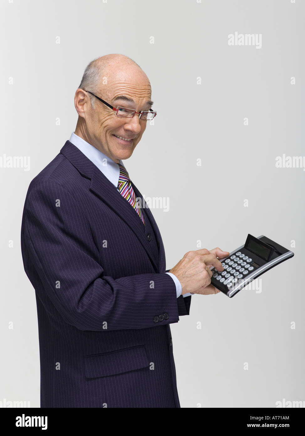 Businessman holding calculator, portrait Stock Photo - Alamy