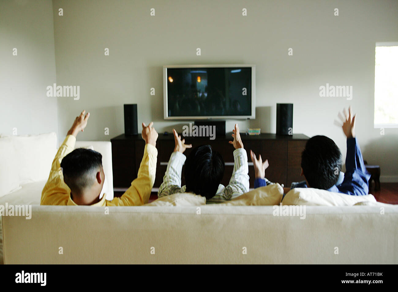 3 Men Cheering While Watching Flatscreen Television Stock Photo - Alamy