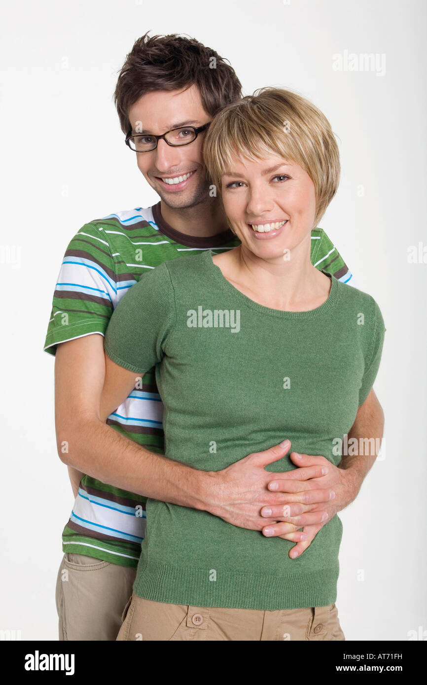 Front view portrait of young couple with arms around each other Stock ...