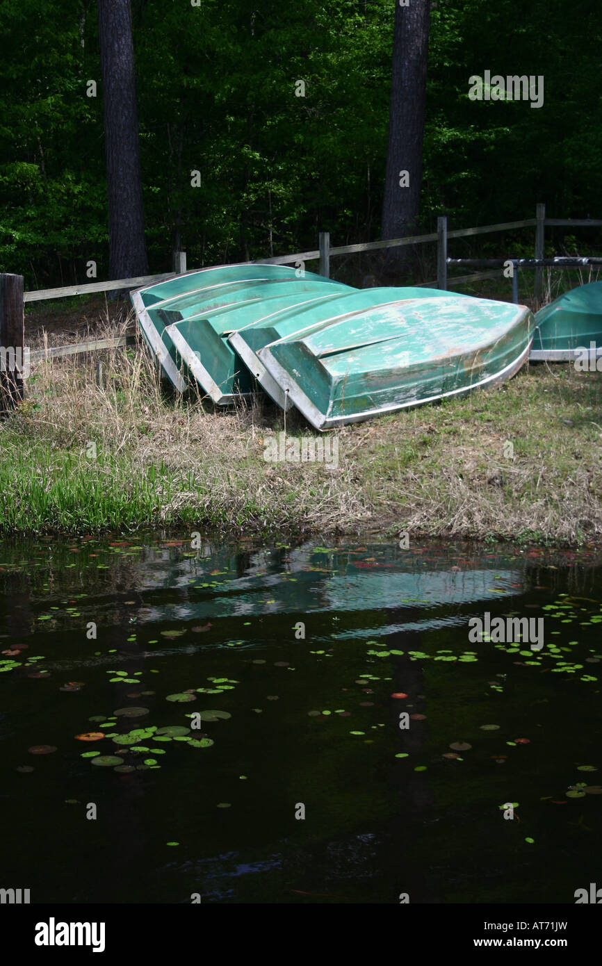 A row of canoes on lake at cub scouts camp Stock Photo - Alamy