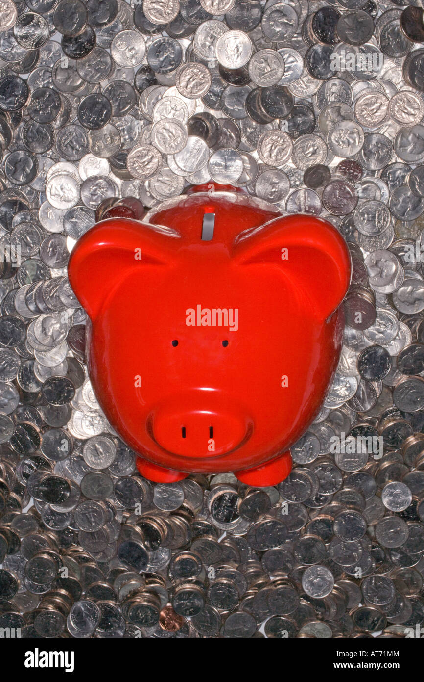 Red piggy bank with U.S. coins Stock Photo - Alamy