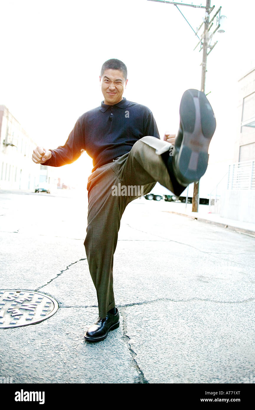 Man Kicking on an Industrial Street Stock Photo - Alamy
