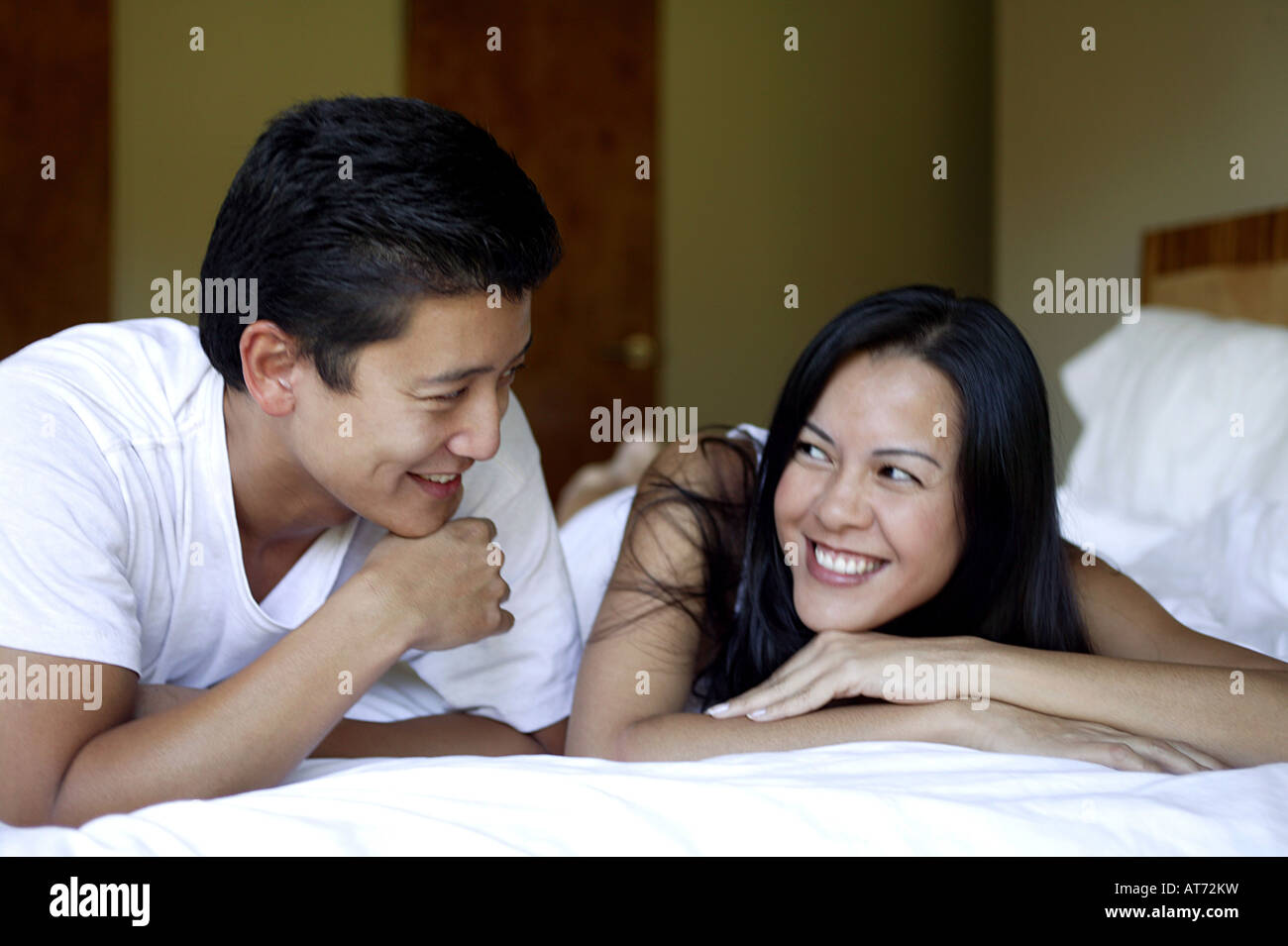 A Couple Laying in Bed Stock Photo - Alamy
