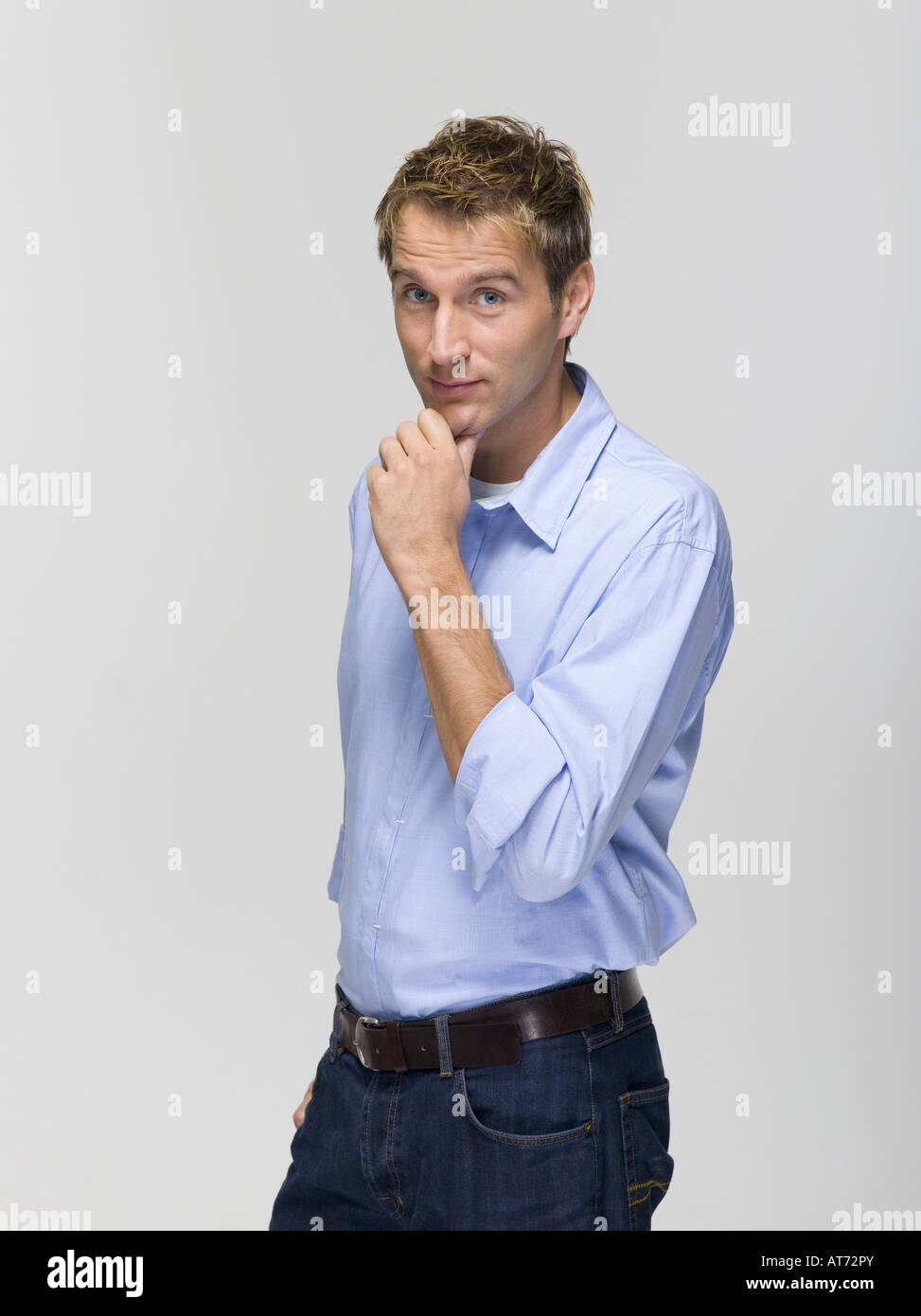 Young man hand on chin, portrait Stock Photo - Alamy