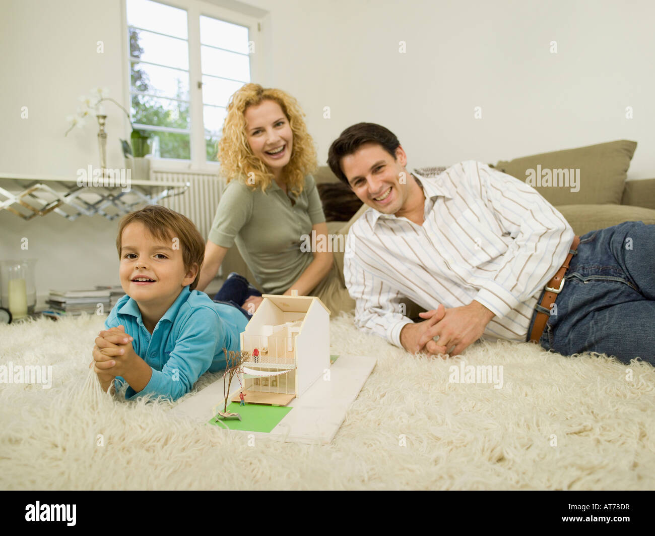 Young family in living room Stock Photo - Alamy