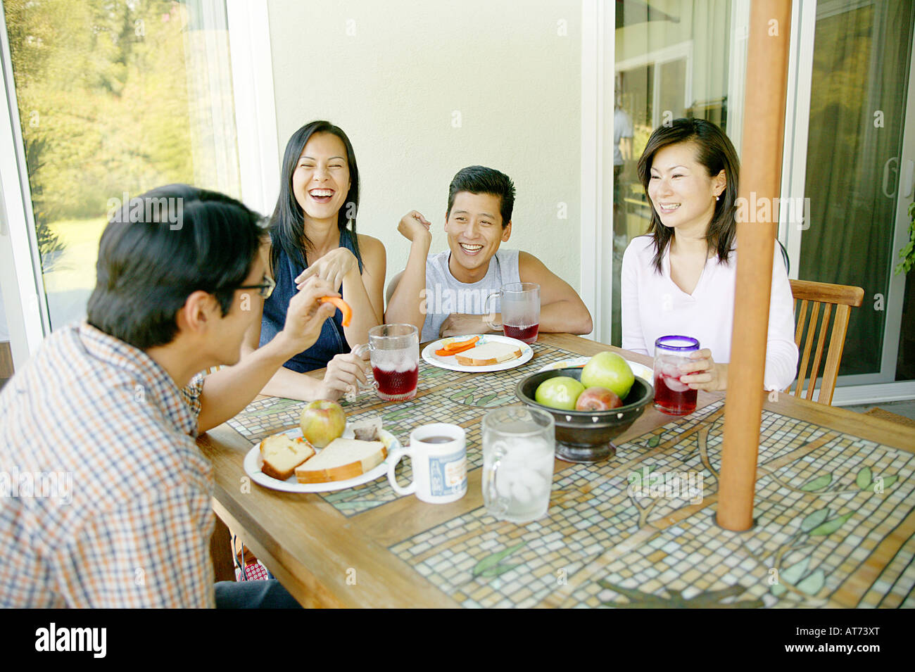 Group Eating at Outside Table Stock Photo - Alamy