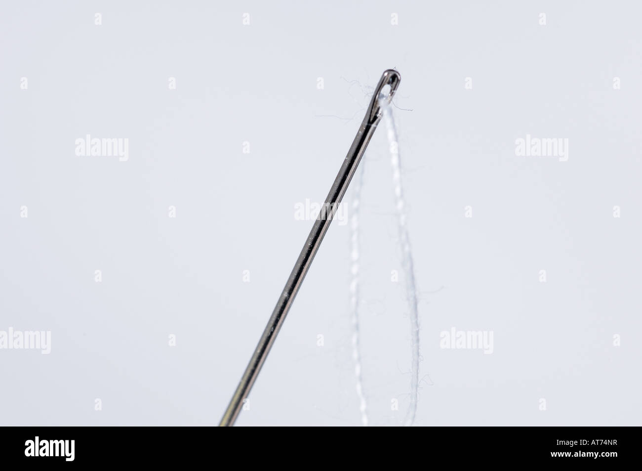 A needle with a threat Stock Photo - Alamy