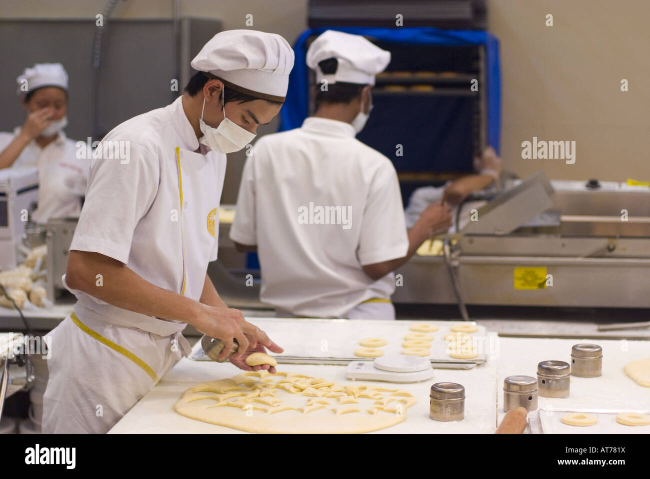 Young man cutting doughnuts, The Curve, Kuala Lumpur, Malaysia Stock ...