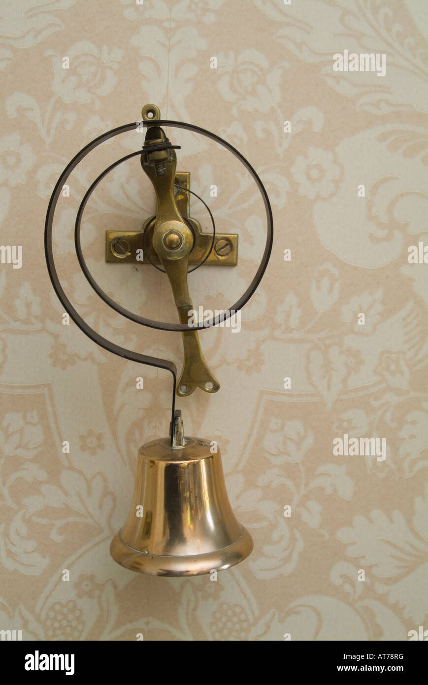A wall mounted brass bell on a spring Stock Photo - Alamy