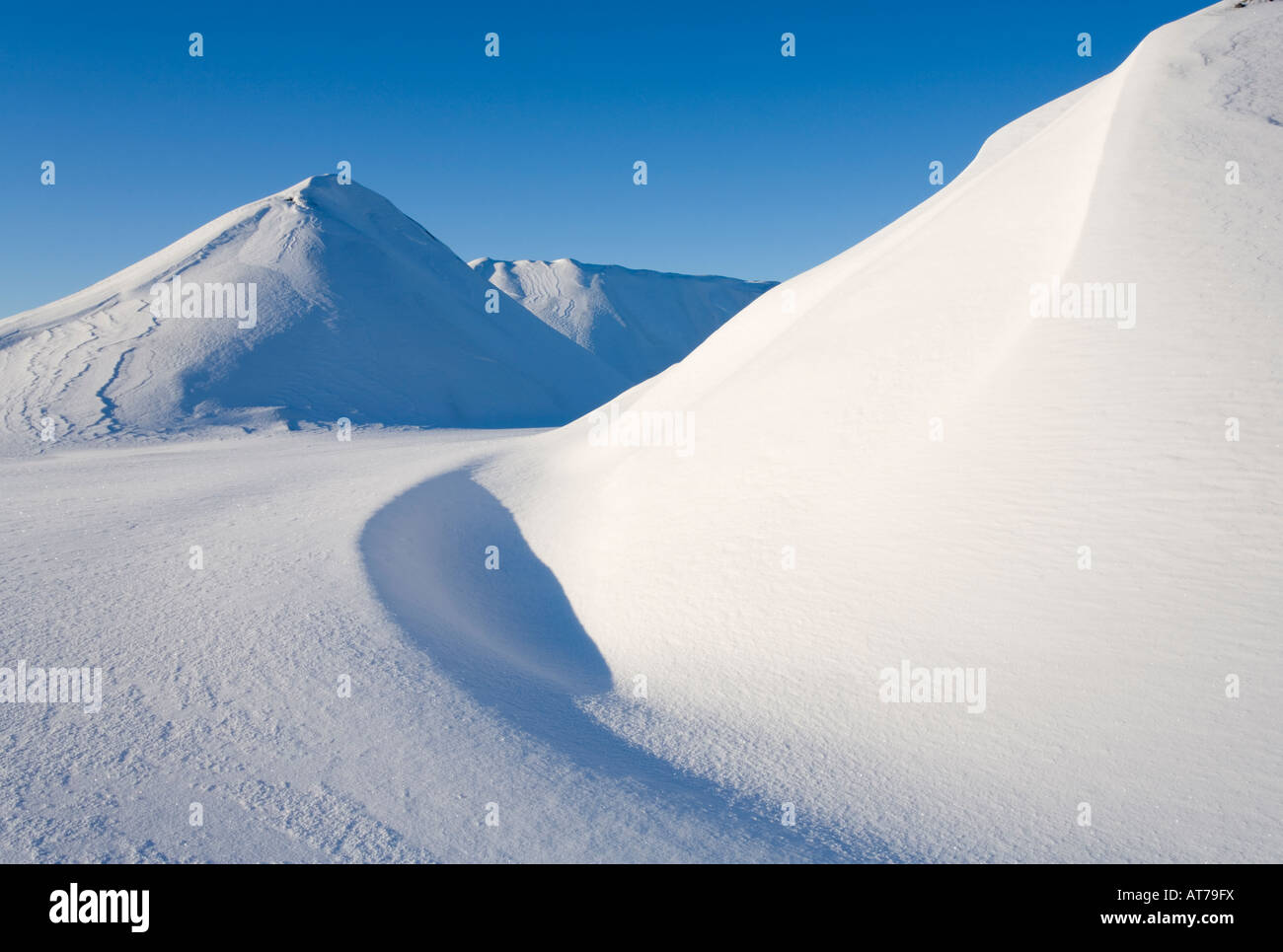 Wind formed patterns on a snow covered mounds at winter , Finland Stock ...