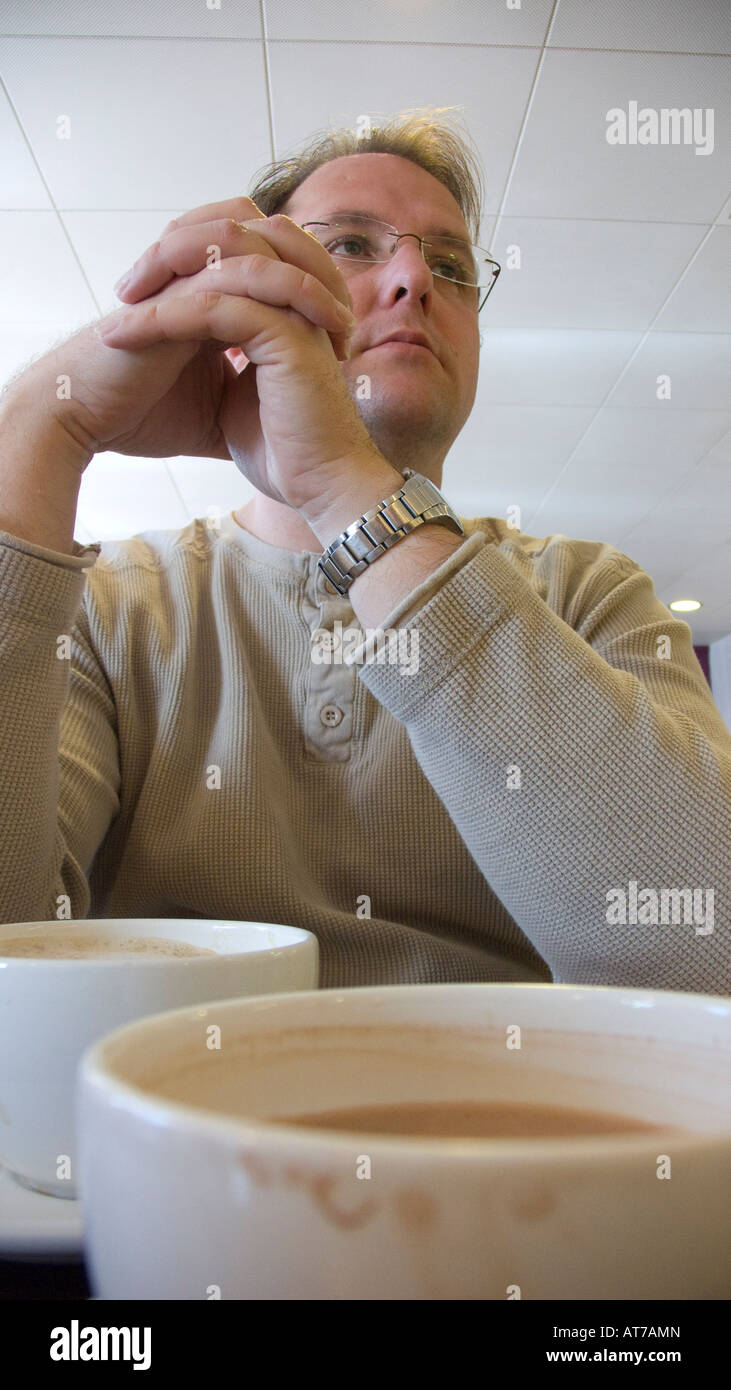 Man and cups of tea Stock Photo - Alamy
