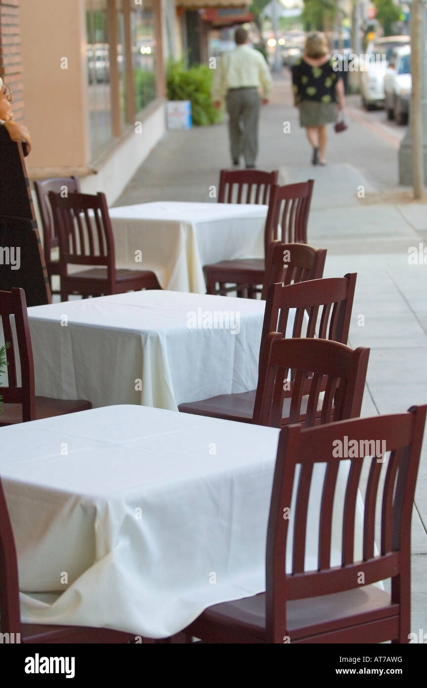 White tablecloths adorn tables at a sidewalk cafe in Orange County ...
