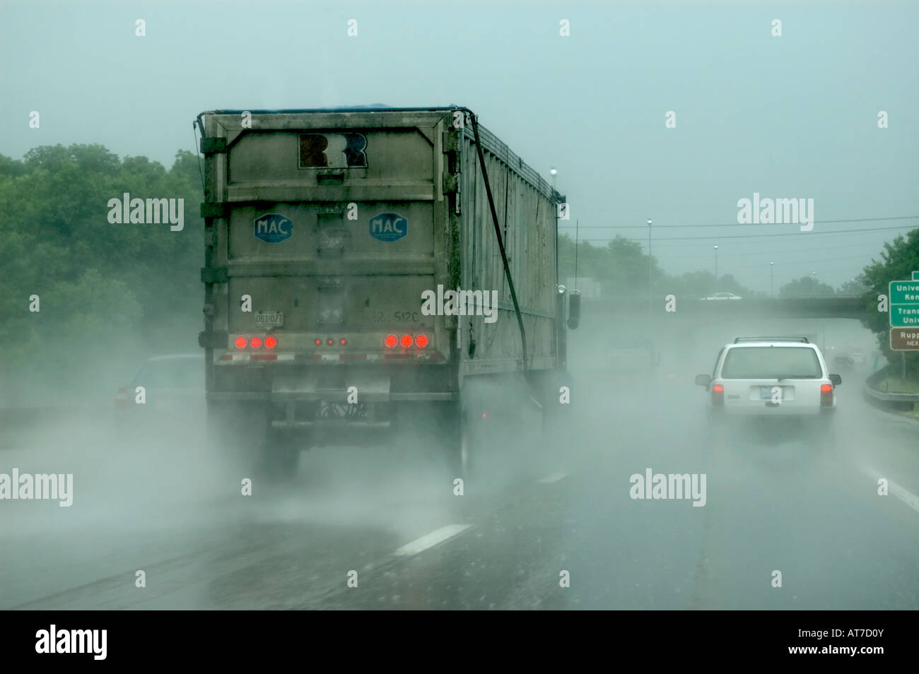 Tractor trailer truck traveling on a Interstate Highway on a rainy day ...