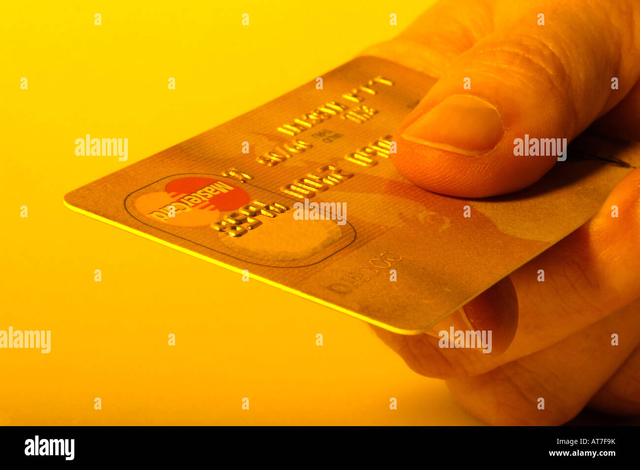 credit card in hand yellow gold numbers code sign bank pay plastic ...
