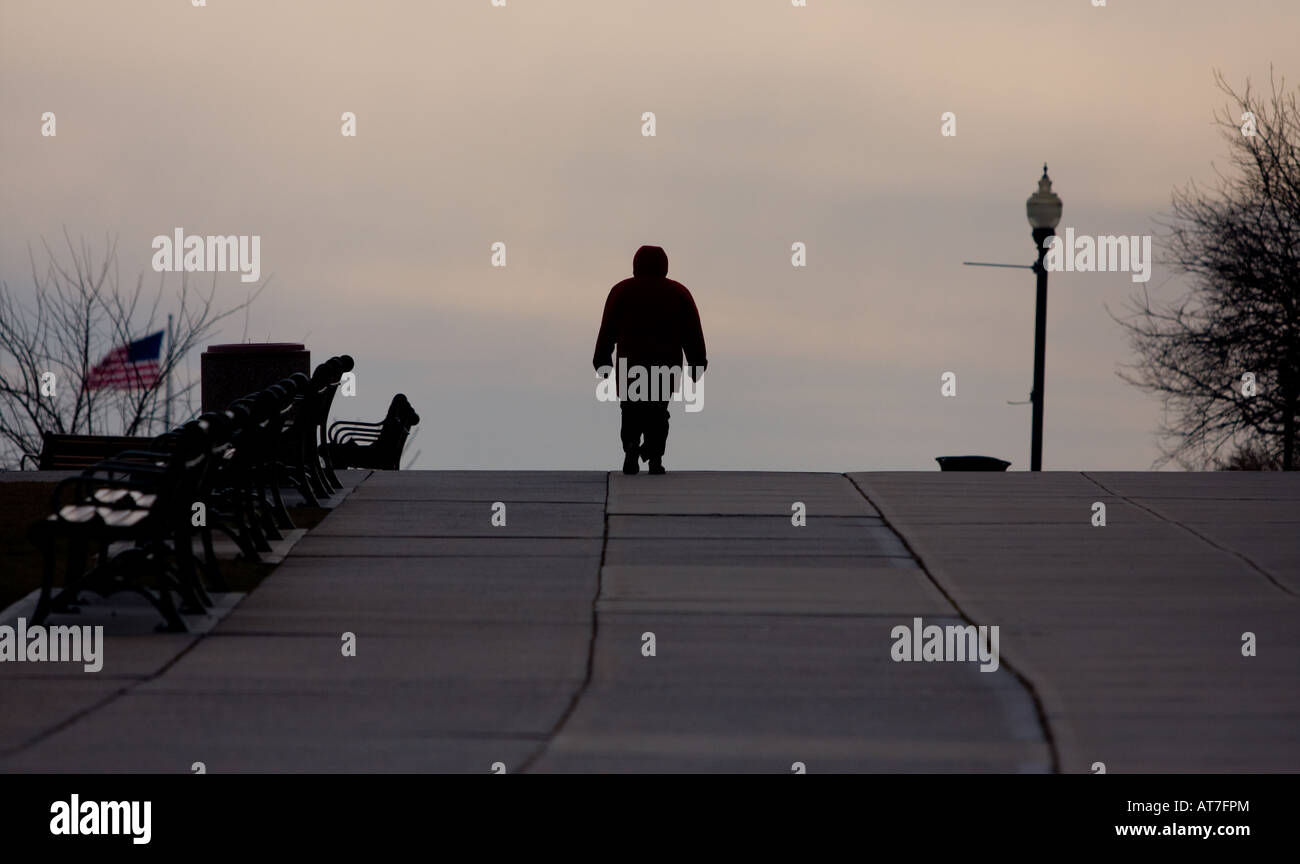 A walker walks along a boardwalk in West Haven Connecticut USA during ...